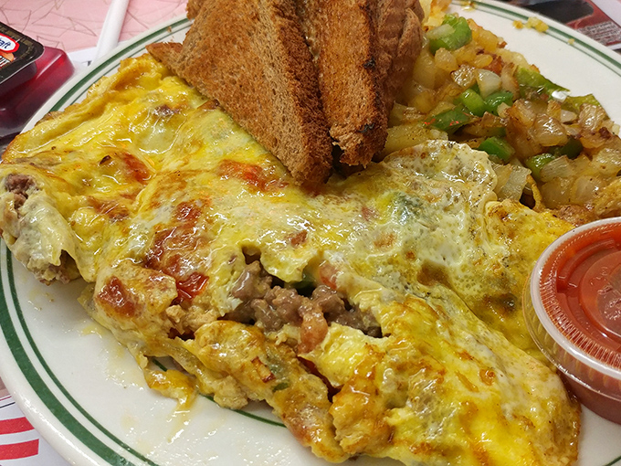 An omelet that deserves its own zip code. Cheese cascades over perfectly cooked eggs alongside home fries that could make a potato proud.