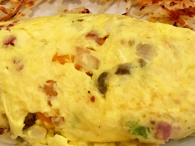This omelet arrived stuffed fuller than your Uncle's Thanksgiving pants, proving that Denver's not just a city, it's a lifestyle choice.