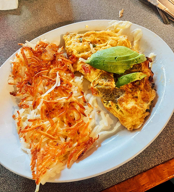 This omelet doesn't just come with hash browns and avocado&mdash;it arrives with the confidence of something that knows it's about to make your day.