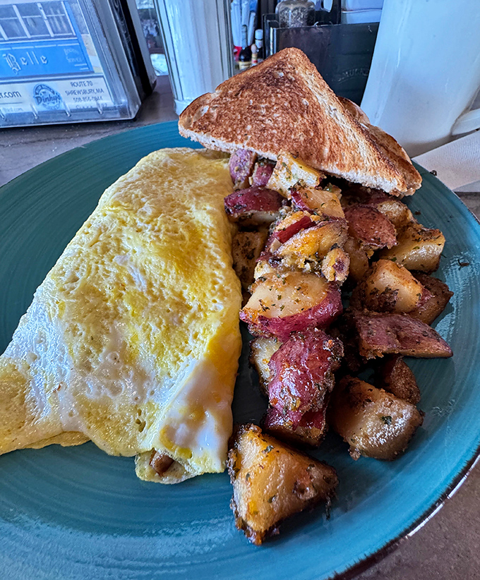 A perfect omelet is like a good marriage&mdash;what's inside matters. Paired with those home fries, it's breakfast harmony on a blue plate.