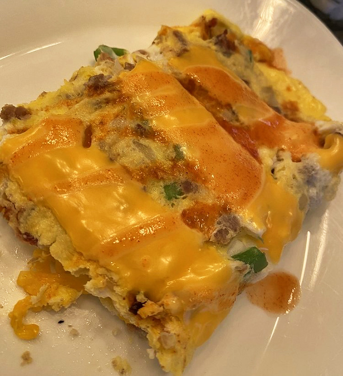 Cheese cascading over a hearty omelet stuffed with savory fillings&mdash;proof that breakfast foods are actually works of art in disguise.