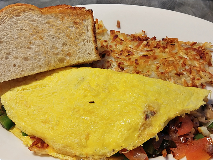 The perfect omelet&mdash;fluffy on the inside, slightly browned on the outside&mdash;paired with crispy hash browns that shatter like breakfast glass when your fork hits them.