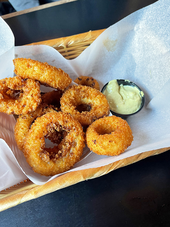 Onion rings with the structural integrity of Olympic medals, golden-crisp and worthy of their own podium ceremony.