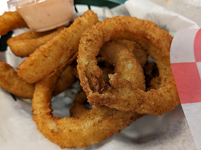 Golden halos of deep-fried perfection. These onion rings aren't just sides &ndash; they're the supporting actors that deserve their own Oscar.