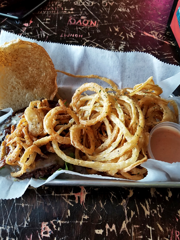 Onion strings so perfectly fried they're practically wearing little golden halos. The dipping sauce is just their way of showing off.