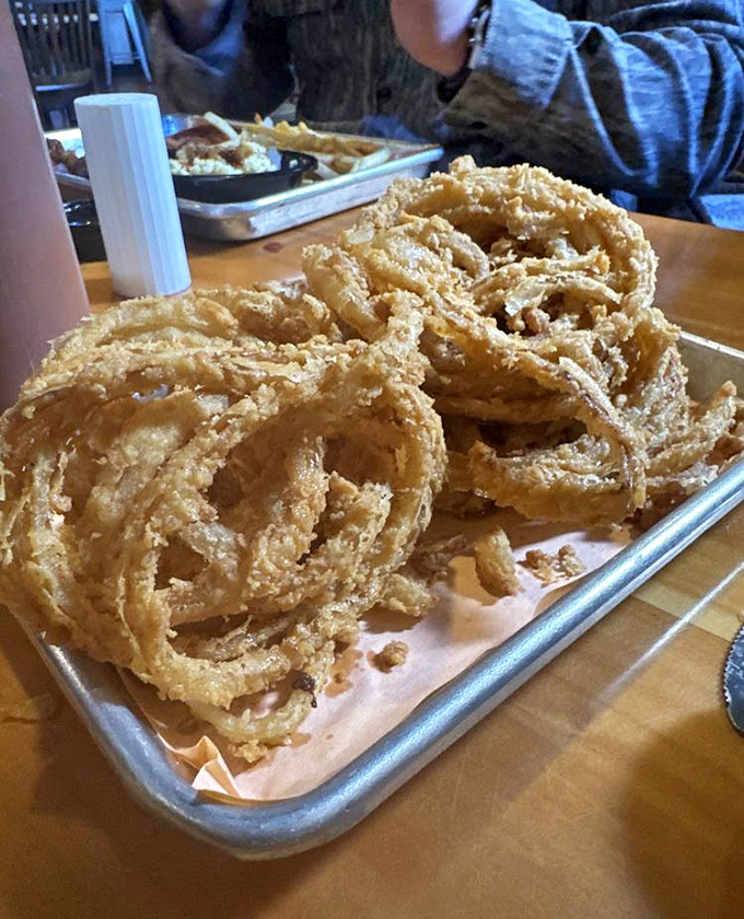 These onion rings aren't just fried—they're transformed into golden halos of crispy perfection that make you forget vegetables were ever healthy.
