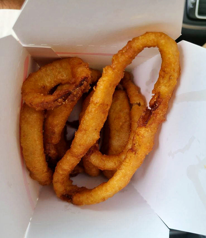 Golden, crispy onion rings that shatter with each bite &ndash; the kind that make you wonder why anyone bothers with those sad frozen circles elsewhere.