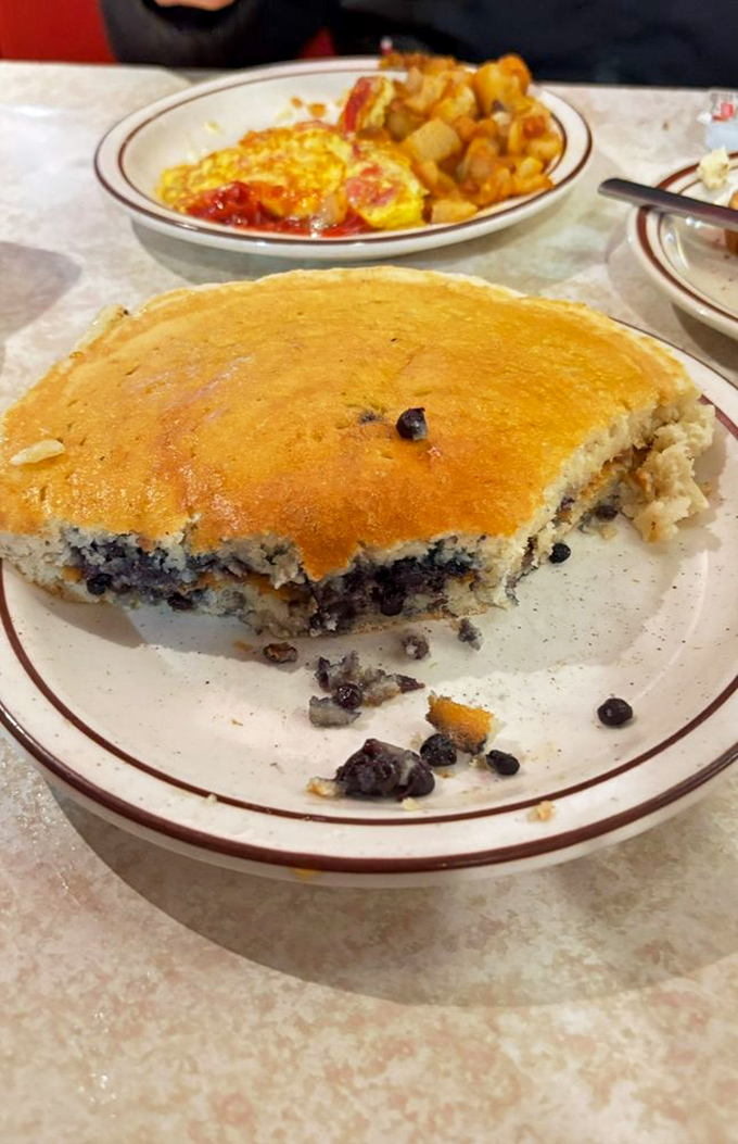 Blueberry pancakes so fluffy they practically hover above the plate, with home fries that demand equal attention.