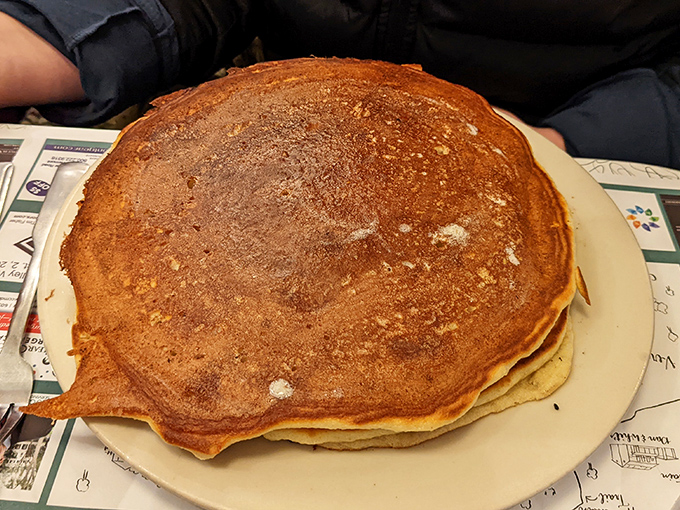 Pancakes so perfectly golden they look like they were touched by King Midas himself. The plate-covering circumference isn't excess&mdash;it's exactly what your soul ordered.