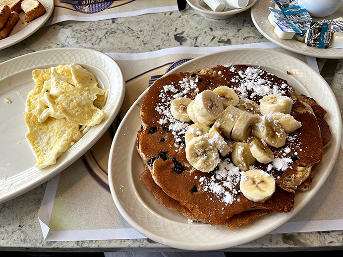 Fluffy pancakes standing tall like edible skyscrapers, ready for their maple syrup baptism.
