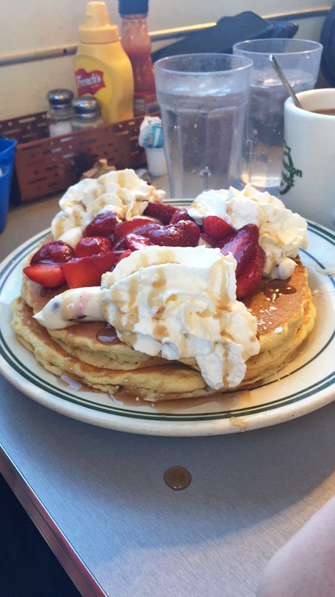 Pancakes that deserve their own zip code, crowned with strawberries and whipped cream. Diet plans enter at their own risk.