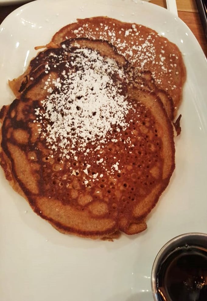 This pancake isn't just cooked&mdash;it's been sweet-talked to golden-brown perfection. The powdered sugar snowfall is just showing off at this point.