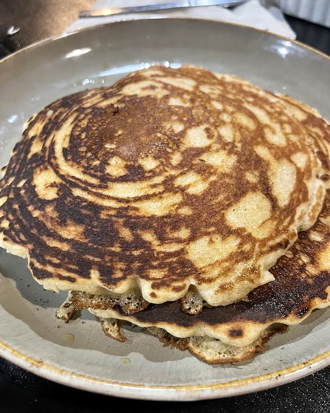 These pancakes have achieved that mythical balance&mdash;crisp edges giving way to pillowy centers that absorb syrup like they were born for it.