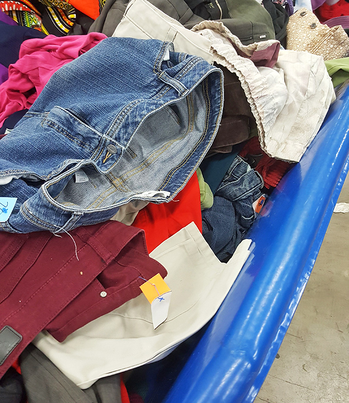 Denim archaeology at its finest. Each layer reveals fashion history—from high-waisted mom jeans to designer denim that someone outgrew.