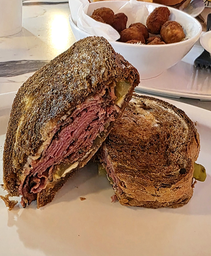 That pastrami sandwich is stacked so high it defies the laws of physics and possibly several local building codes too.