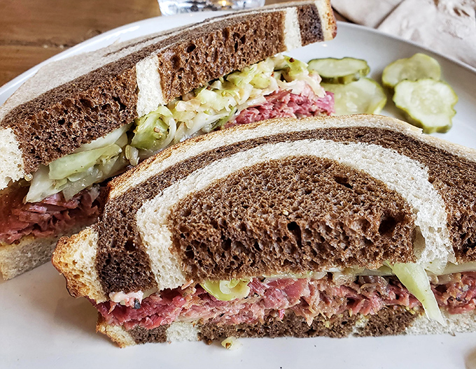 Marbled rye embracing pastrami and slaw in a sandwich romance that would make Broadway jealous. Those house-made pickles are the perfect chaperones.