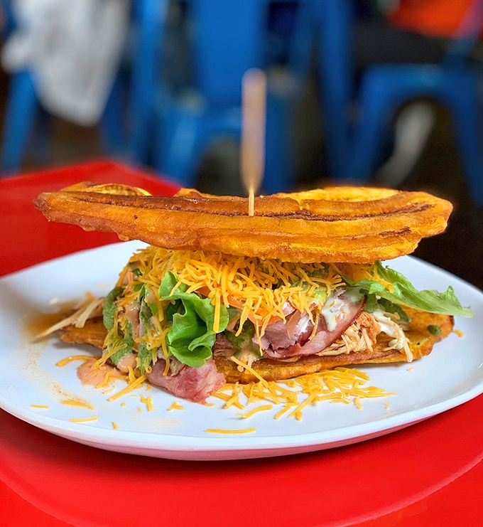 The patacone sandwich replaces bread with fried plantains, proving that sometimes the best culinary ideas come from thinking completely outside the bread box.