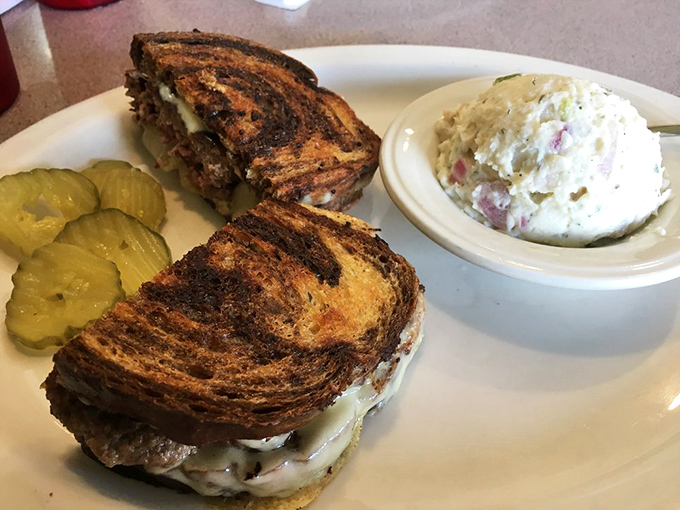 A patty melt that delivers on its promises: perfectly grilled bread, melty cheese, and a side of potato salad that didn't come from a bucket.