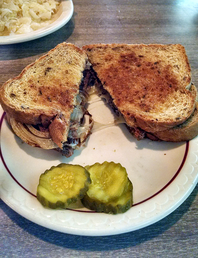 The patty melt: where bread meets beef meets cheese in a holy trinity of diner perfection. Those pickle chips aren't just garnish&mdash;they're essential tang.