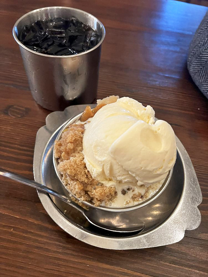Peach cobbler with ice cream &ndash; because sometimes happiness comes in a bowl with a spoon on the side.