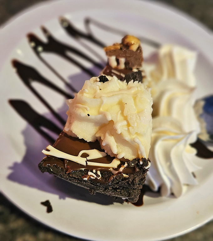 Chocolate, peanut butter, and whipped cream&mdash;the holy trinity of dessert perfection. This slice doesn't just end your meal; it becomes the reason you came.