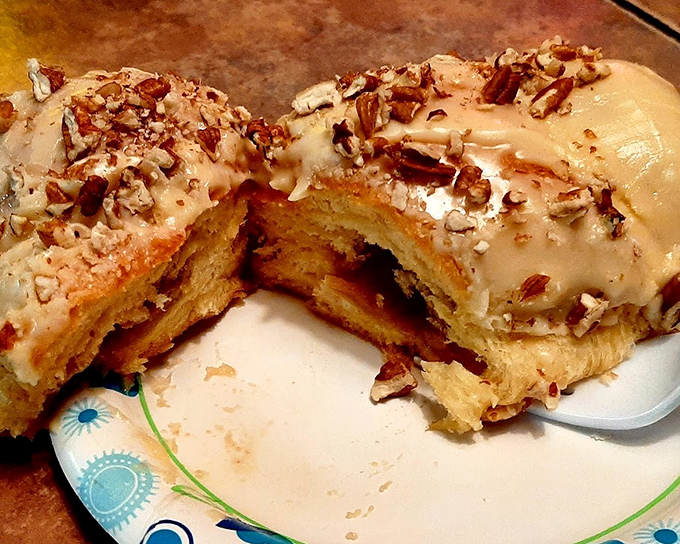 Behold the pecan roll&mdash;where maple glaze cascades over pillowy dough like a sweet waterfall, with crunchy nut confetti celebrating your excellent life choices.