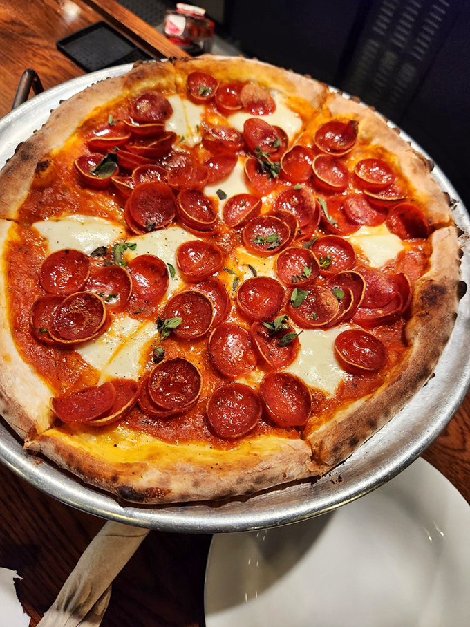 Pepperoni that curls into little flavor cups, collecting precious oils like tiny edible chalices. This isn't just pizza &ndash; it's architecture with attitude.