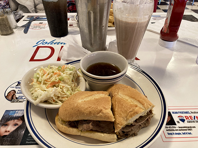 The French dip sandwich arrives with enough meat to feed a small village, accompanied by coleslaw that actually deserves to be eaten, not pushed aside.