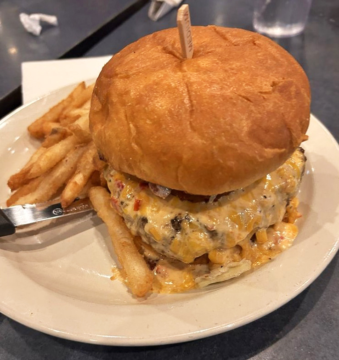 This isn't just a burger&mdash;it's a towering monument to excess that requires both hands, several napkins, and absolutely zero regrets. 