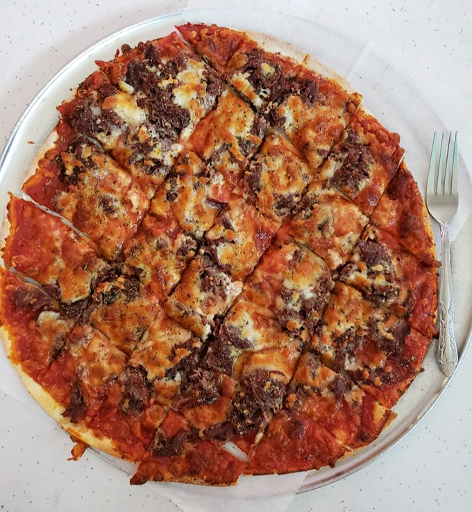 Chicago thin crust perfection in its natural habitat&mdash;crispy, square-cut, and topped with sausage that means business.