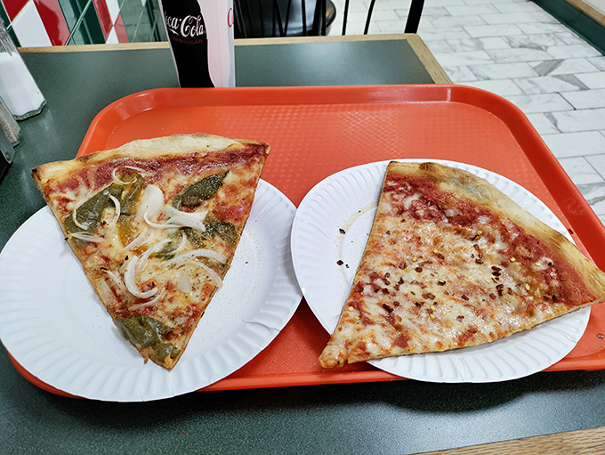 Pizza by the slice &ndash; the way nature intended. One traditional cheese, one loaded with toppings, both representing pizza perfection.