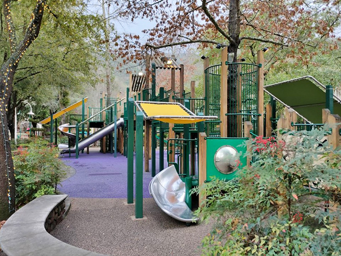 Playground equipment nestled among trees creates that perfect balance where kids can play while parents pretend they're actually in a peaceful forest.