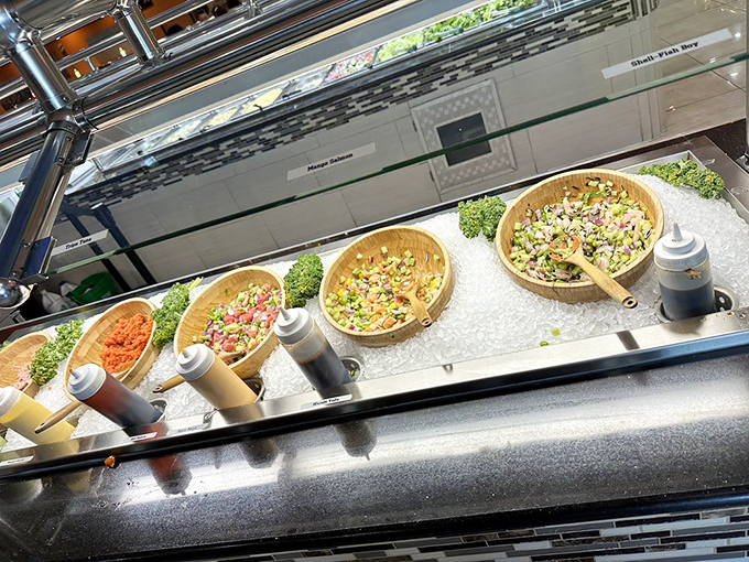 Fresh salad fixings and colorful toppings stand ready for your creative assembly. The wooden bowls add a touch of rustic charm to the presentation.