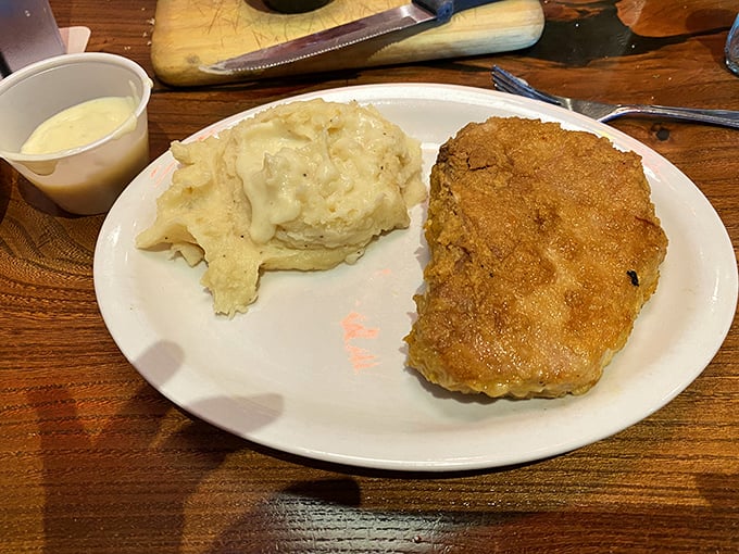 This isn't just a pork chop&mdash;it's comfort on a plate. Creamy mashed potatoes stand by, ready to soak up every last drop of goodness.