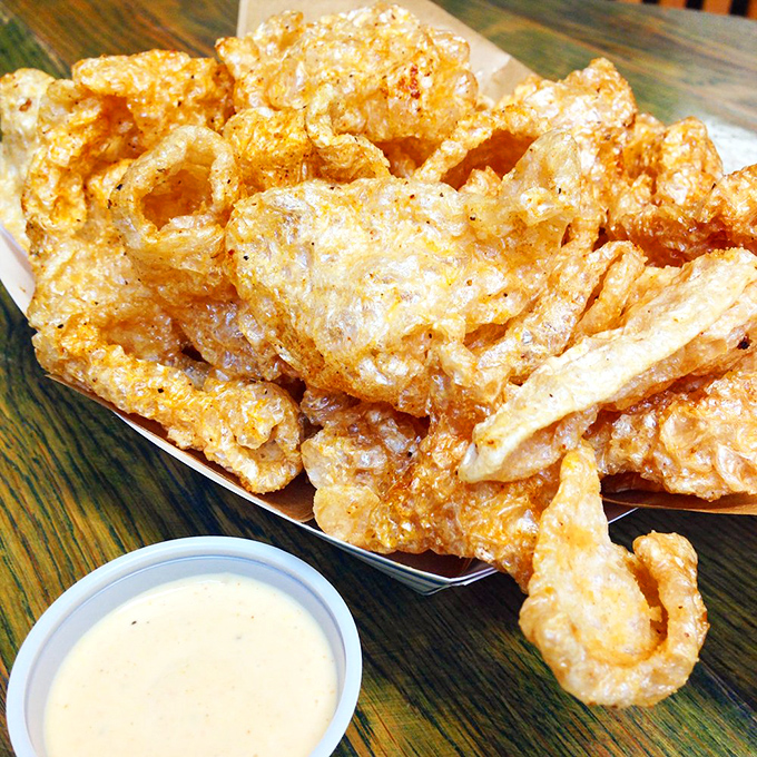 Pork rinds that shatter with a satisfying crunch before melting away. The white sauce alongside isn't optional&mdash;it's the perfect creamy complement to these crispy clouds. 