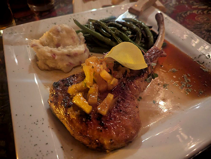 The Pork Tomahawk brings drama to dinner with its impressive bone and pineapple chutney topping—Fred Flintstone would approve of this prehistoric-looking portion.