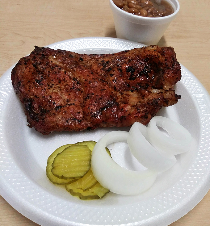 The kind of pork steak that makes vegetarians question their life choices, glistening with a perfect pepper-flecked crust that shatters with each bite.
