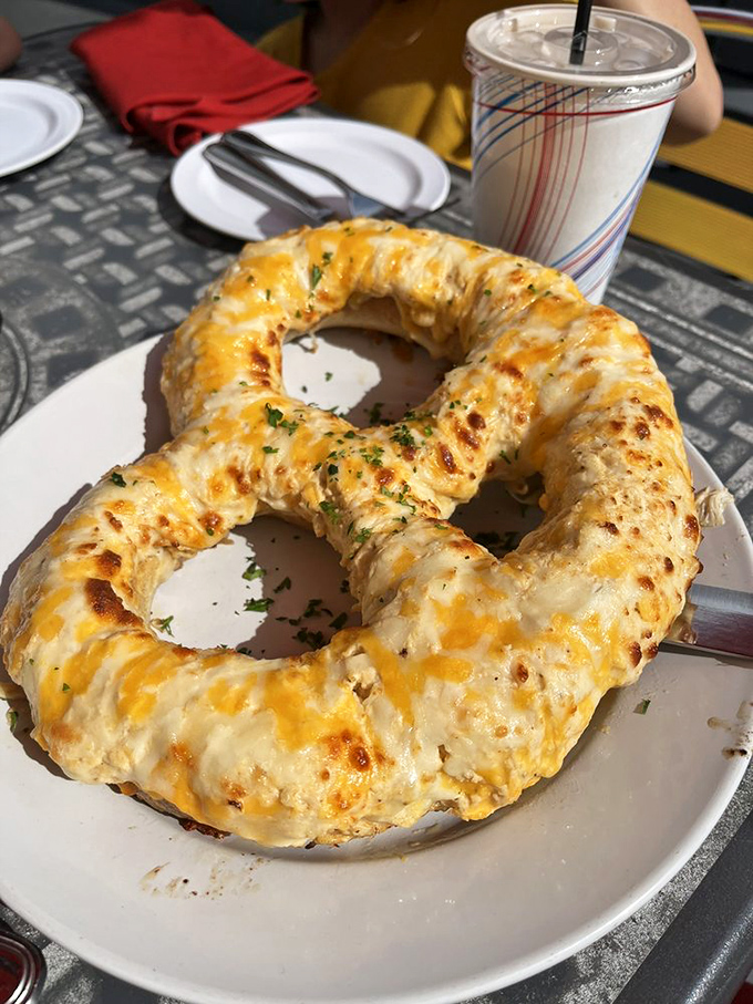 This isn't just any pretzel&mdash;it's a cheese-covered life preserver for the hungry soul. Dive in! 