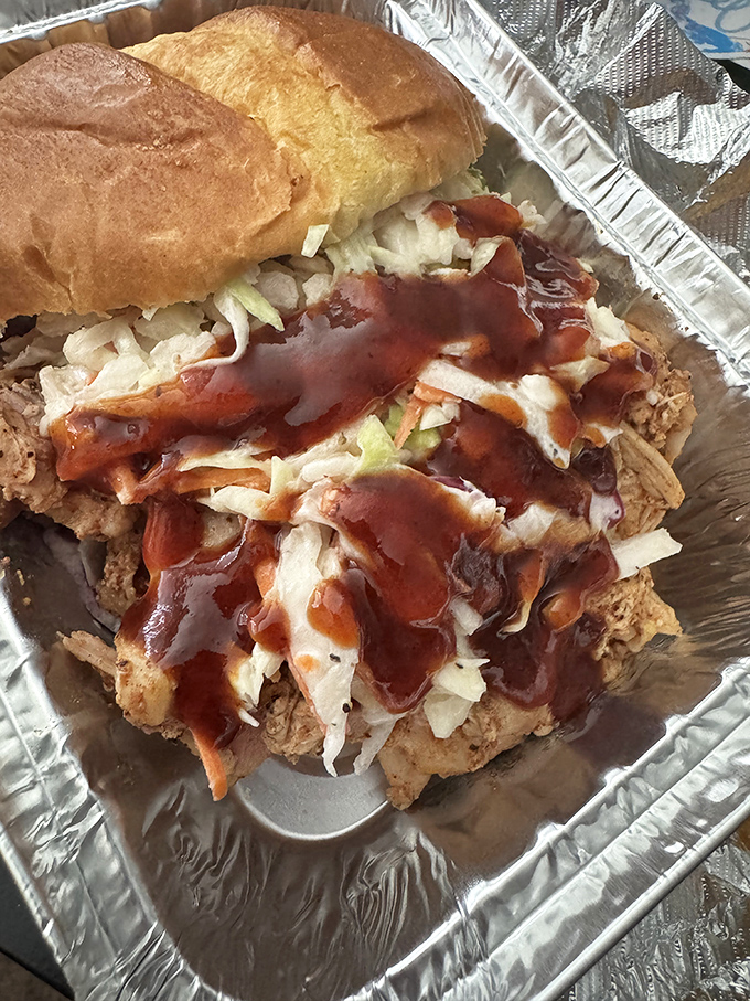 This pulled chicken sandwich towers like a delicious skyscraper, proving poultry deserves respect in the smokehouse too.