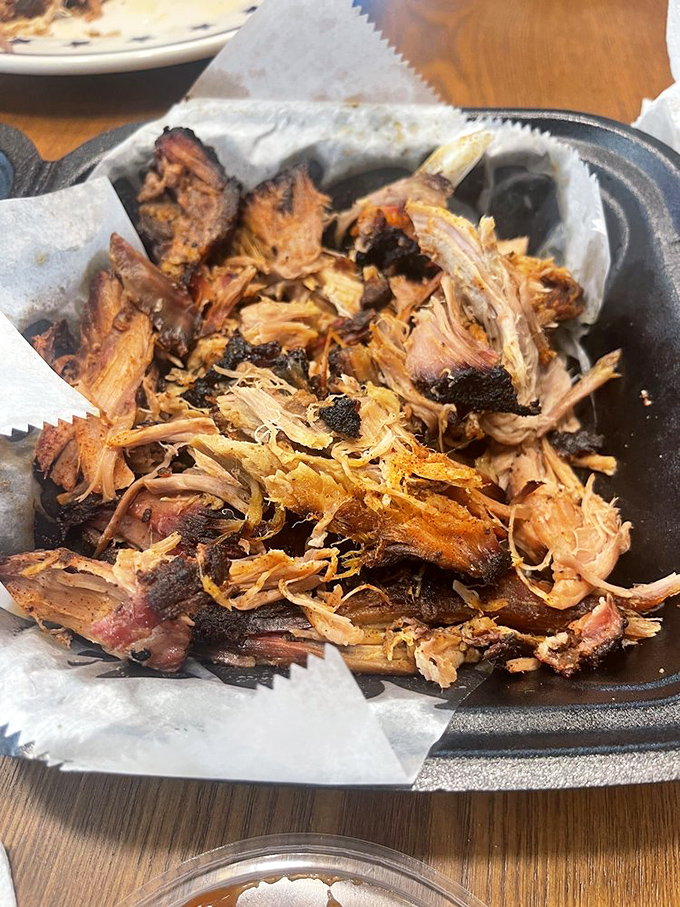Pulled pork that's had a proper introduction to smoke and time. Each strand tells a story of patience that makes you grateful someone else did the waiting.