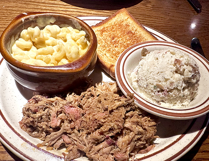 Carolina pulled pork that's had a proper smoke session, paired with creamy mac and cheese that refuses to be overshadowed by its protein companion.