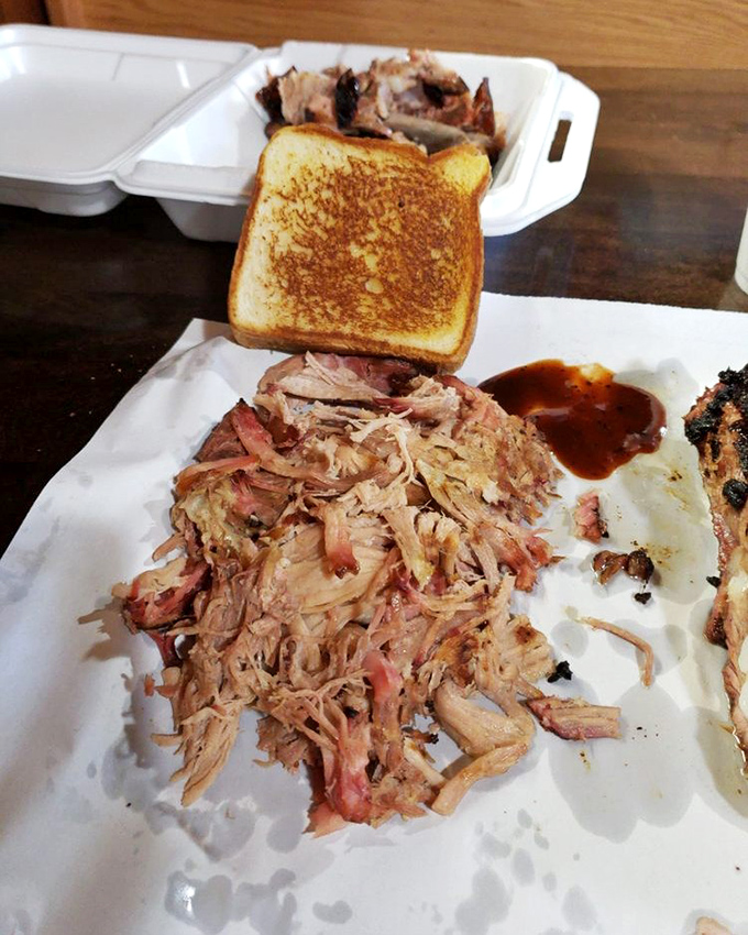 Pulled pork so tender it practically pulled itself, served with Texas toast that's about to embark on its noble mission as a sauce delivery system.