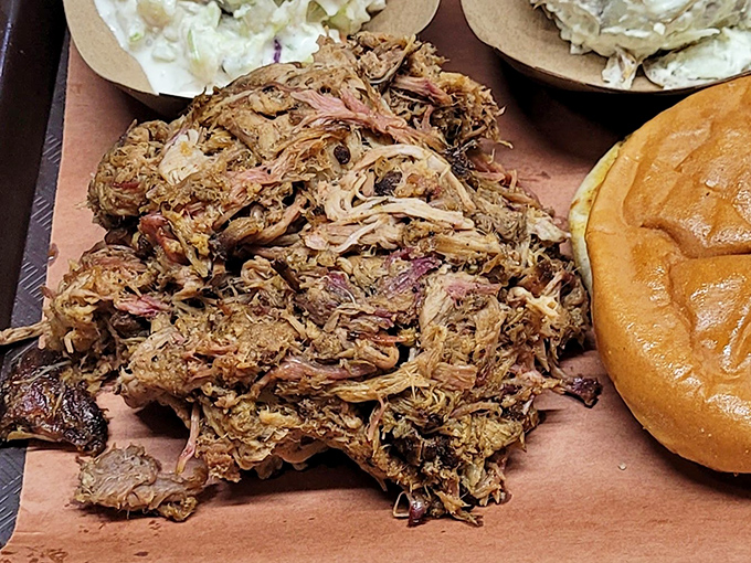 Pulled pork that doesn't need a swimming pool of sauce to impress you. Each strand has absorbed enough smoky goodness to start its own flavor revolution.