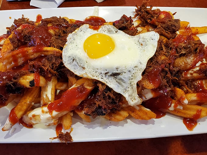 Pulled pork poutine topped with a sunny-side-up egg &ndash; because sometimes breakfast and dinner need to have a beautiful reunion.
