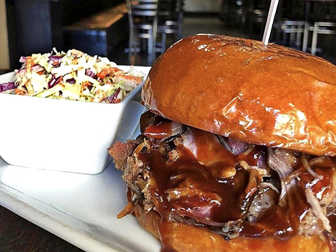 A pulled pork sandwich that doesn't mess around &ndash; just gloriously tender meat, sauce with attitude, and coleslaw for that perfect crunch contrast.