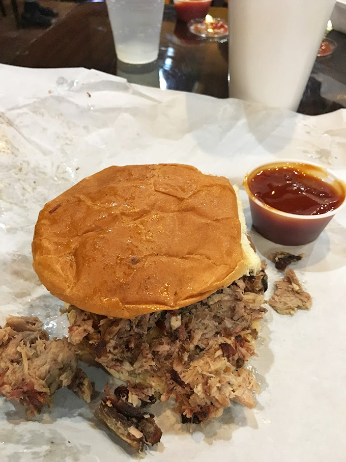 The pulled pork sandwich &ndash; where smoke meets sweet bun in perfect harmony. Notice how it's practically bursting with meat? That's not an accident.