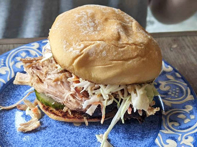 Architecture of joy: a pulled pork slider where each component plays its part perfectly. The slaw provides crunch while the meat brings smoky depth.