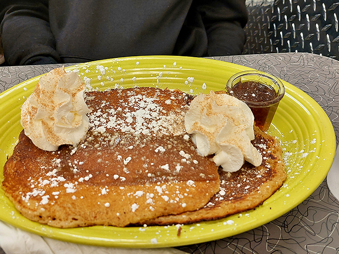 Pumpkin pancakes dusted with powdered sugar and topped with whipped cream – autumn on a plate, even when it's not fall.