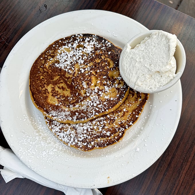 These pancakes aren't just golden brown&mdash;they're treasure discs topped with a cloud of whipped cream that melts into every warm, buttery crevice.