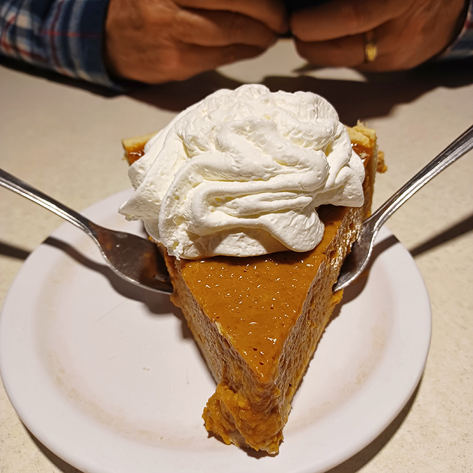 This pumpkin pie topped with a cloud of whipped cream isn't just dessert &ndash; it's an edible time machine to every perfect Thanksgiving you've ever experienced.